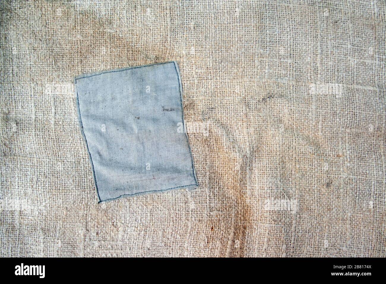 Aged vintage and weathered cloth background texture with patch. Old ...