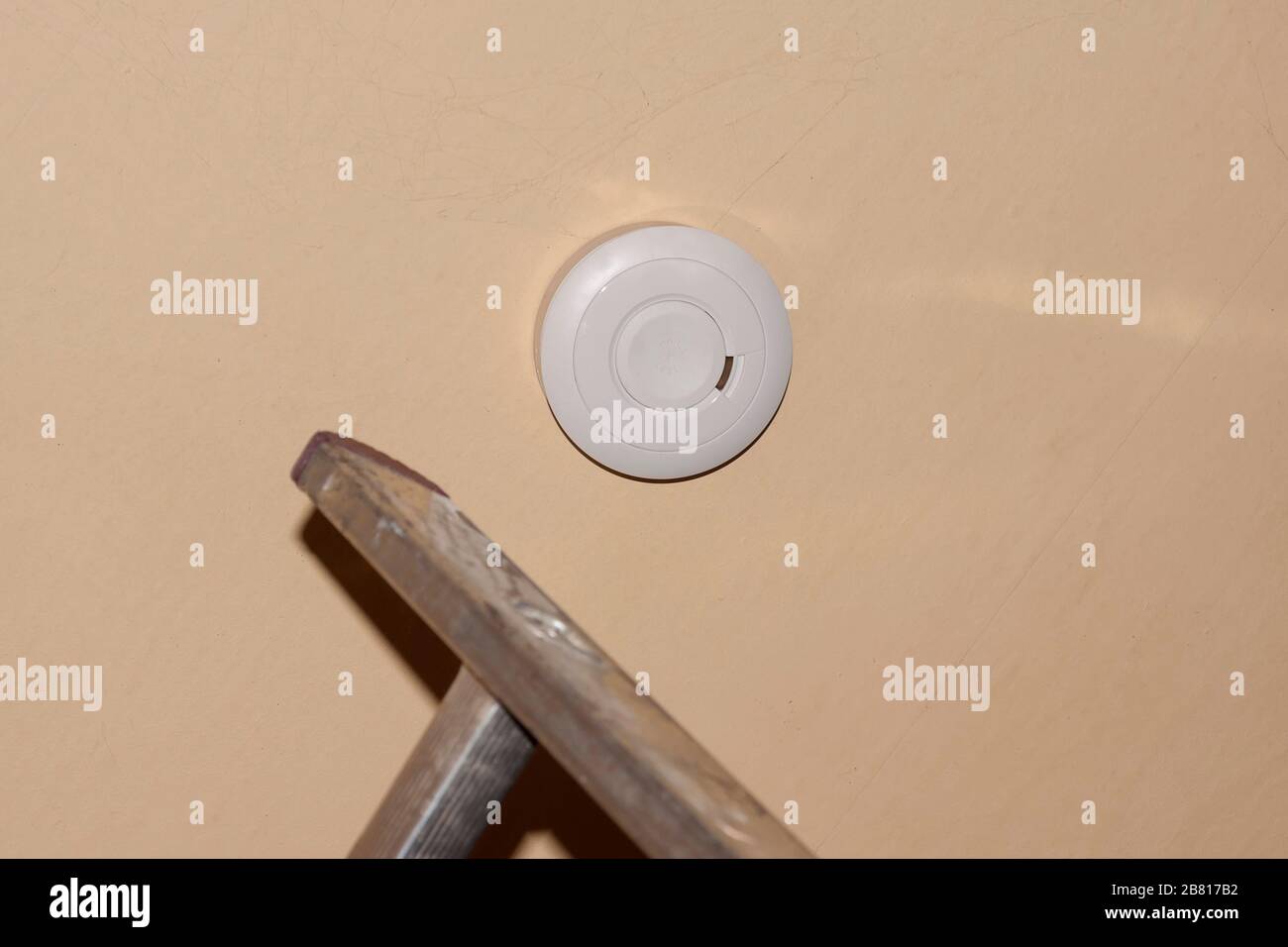 Smoke alarm on a ceiling,Installation of a smoke detector on a ceiling ...