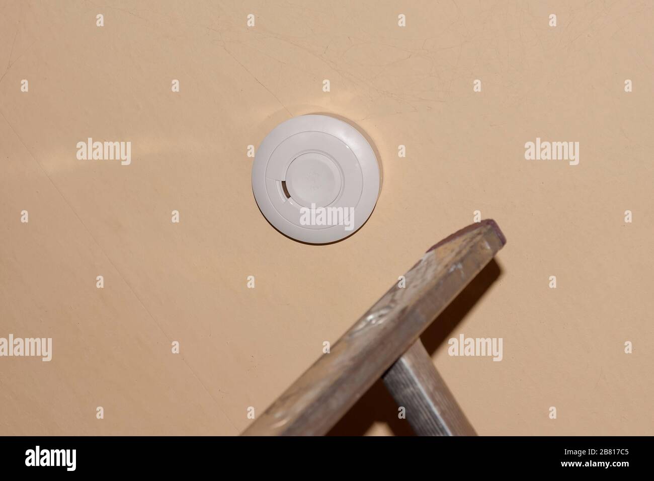Smoke alarm on a ceiling,Installation of a smoke detector on a ceiling ...