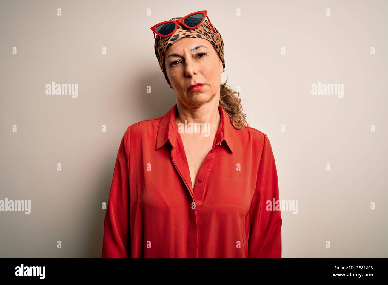 Middle age brunette woman wearing handkerchief on head and shirt over ...