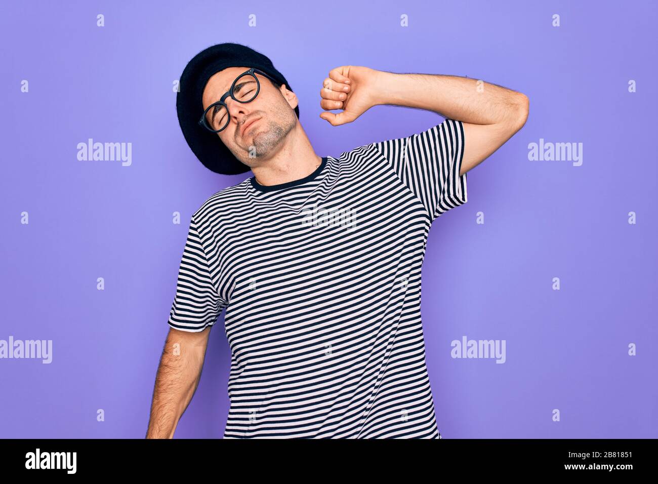 Handsome man with blue eyes wearing striped t-shirt and french beret ...