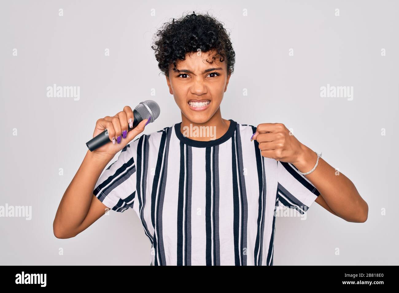 Beautiful african american afro singer woman singing using microphone ...