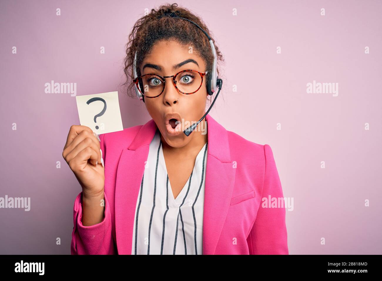 African american call center agent girl working using headset holding ...