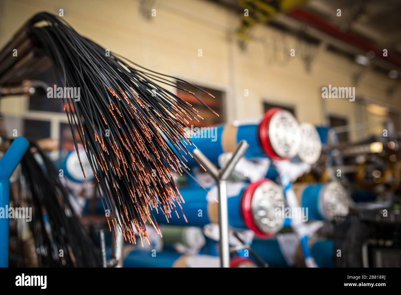 Bundle of wires hangs from pipes in the production of electronic parts ...