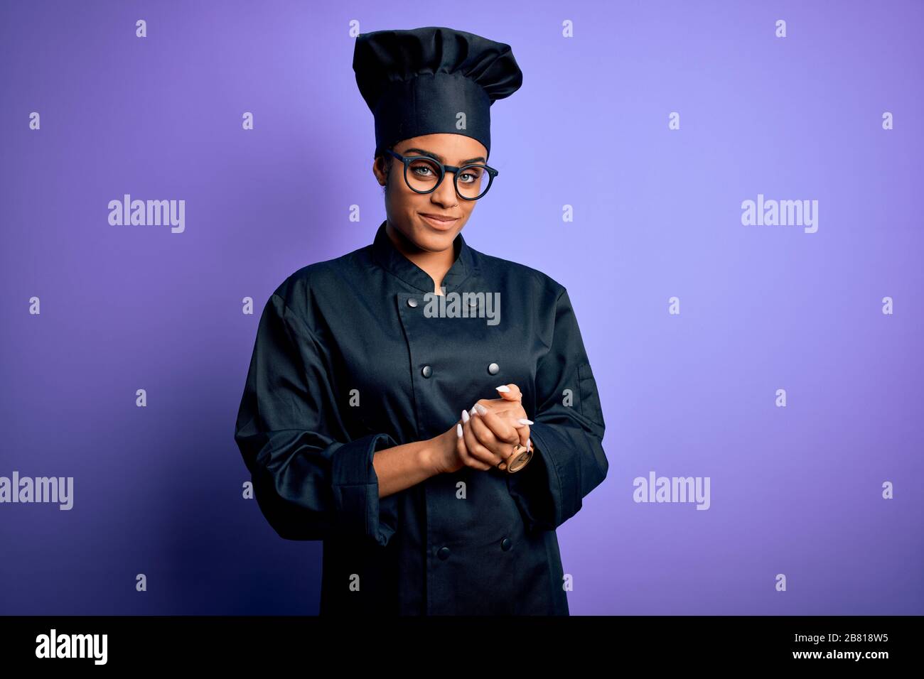 Young african american chef girl wearing cooker uniform and hat over ...