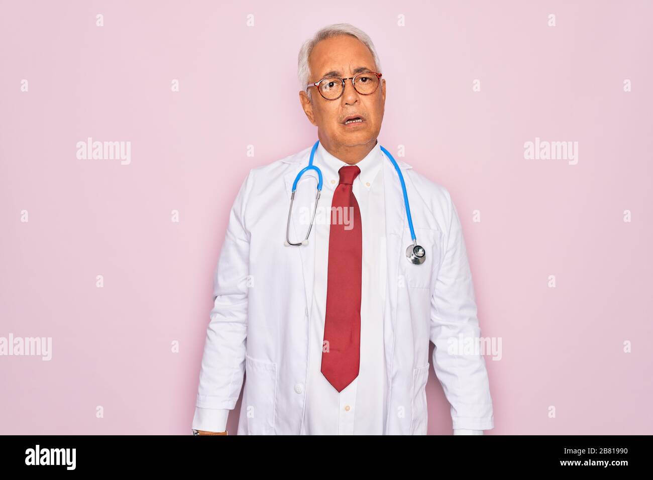 Middle age senior grey-haired doctor man wearing stethoscope and ...