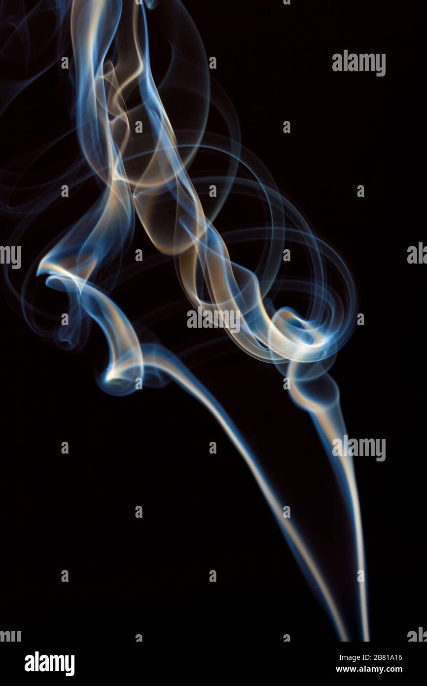 Blue smoke on black background. Smoke and fog spreads and goes from ...