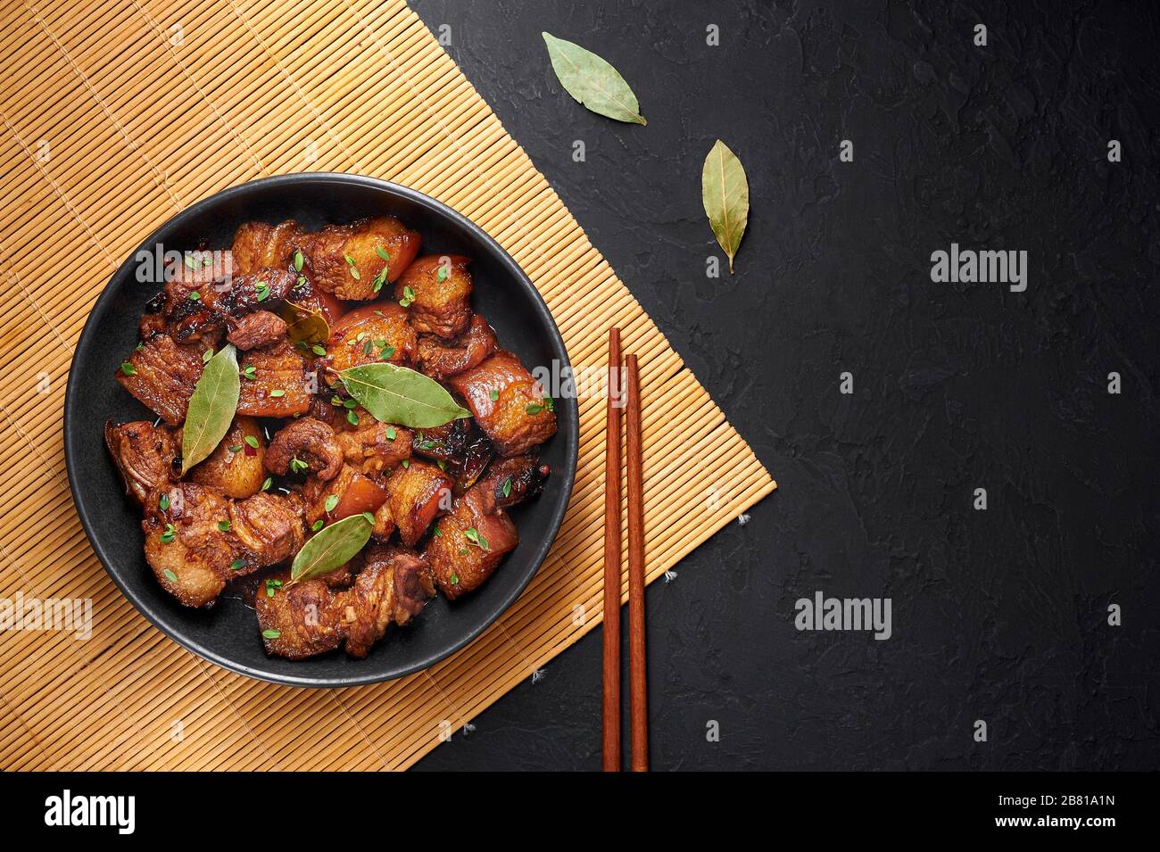 Adobo Pork in black bowl at dark slate background. Pork Adobo or ...