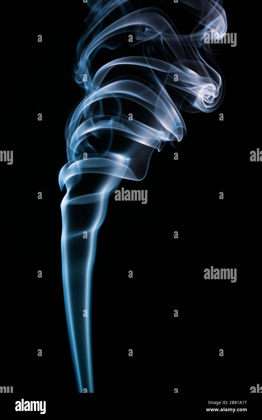 Blue smoke on black background. Smoke and fog spreads and goes from ...