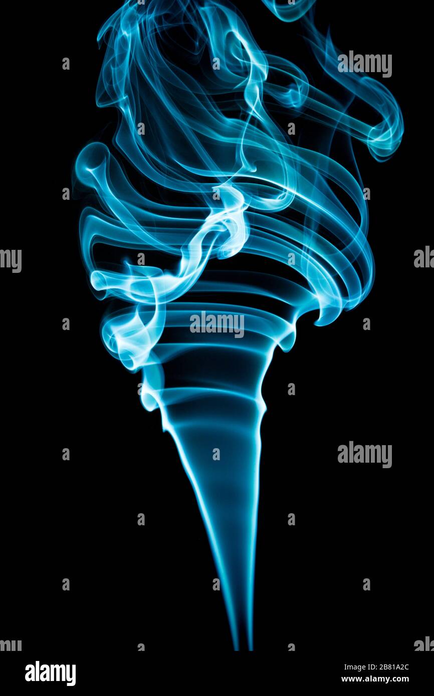 Blue smoke on black background. Smoke and fog spreads and goes from ...
