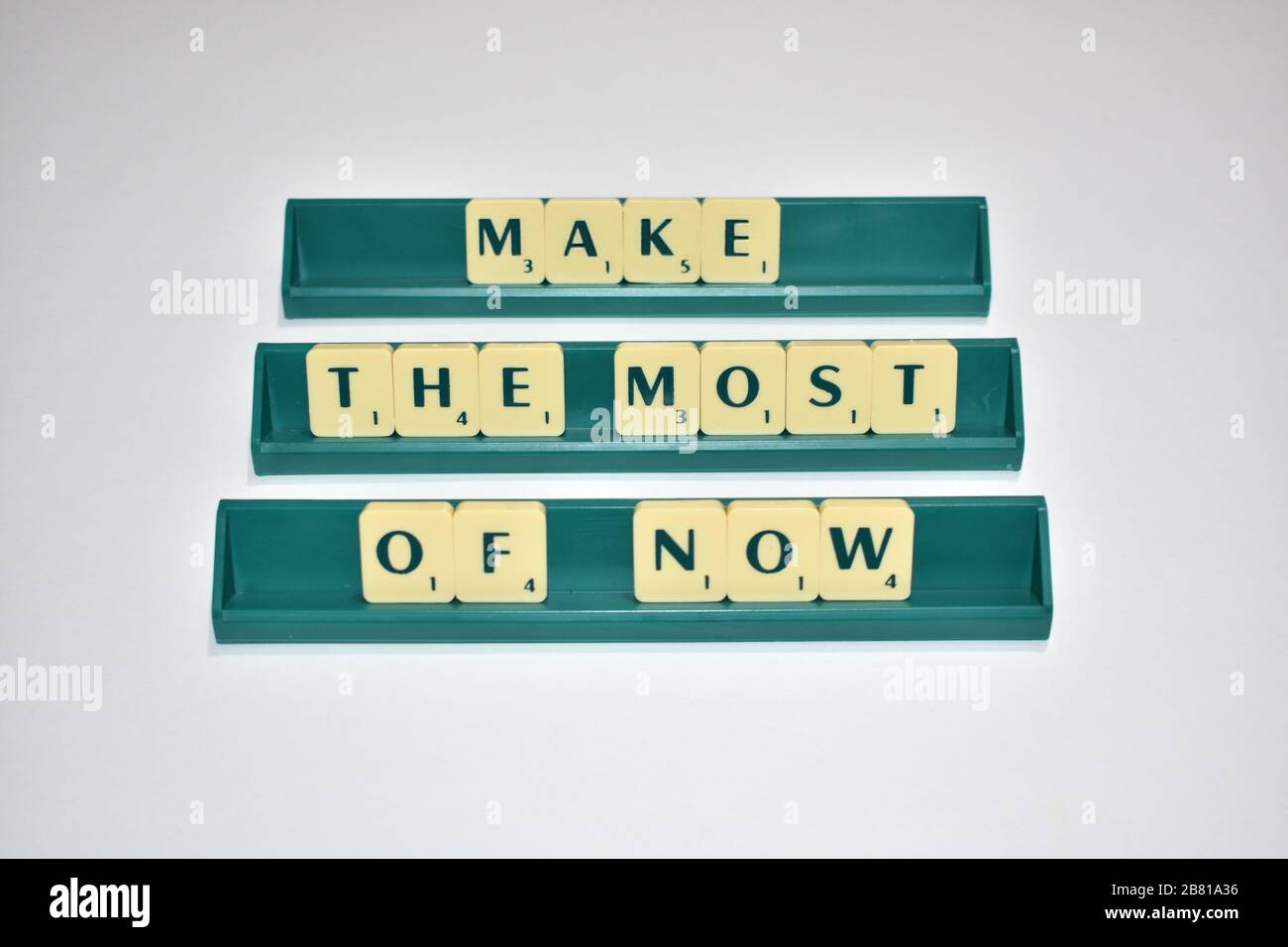 Scrabble tiles spell out Make the Most of Now. Motivational quote ...