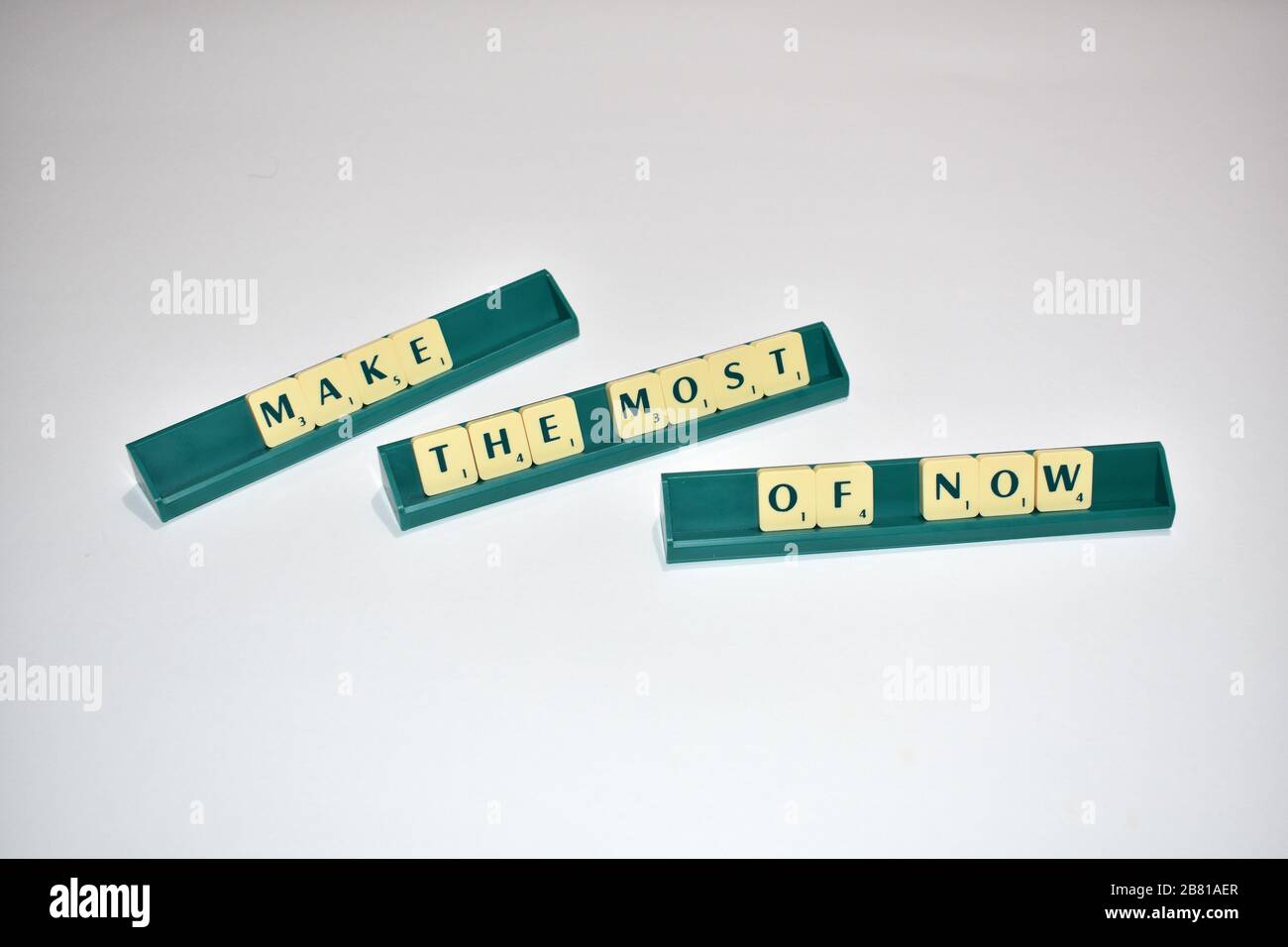 Scrabble tiles spell out Make the Most of Now. Motivational quote ...