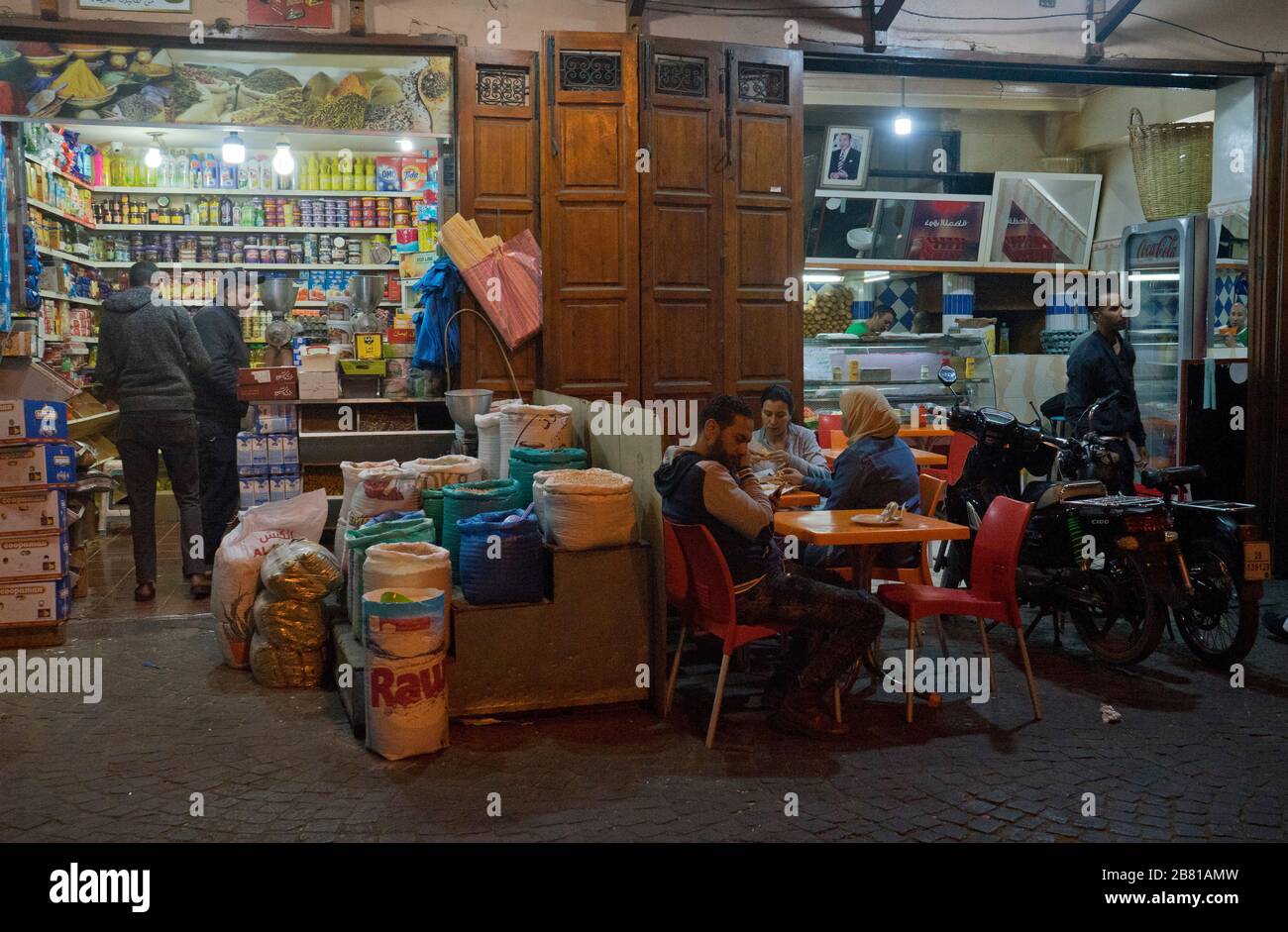 People eating at a small cafe in the souks of the medina old town in ...
