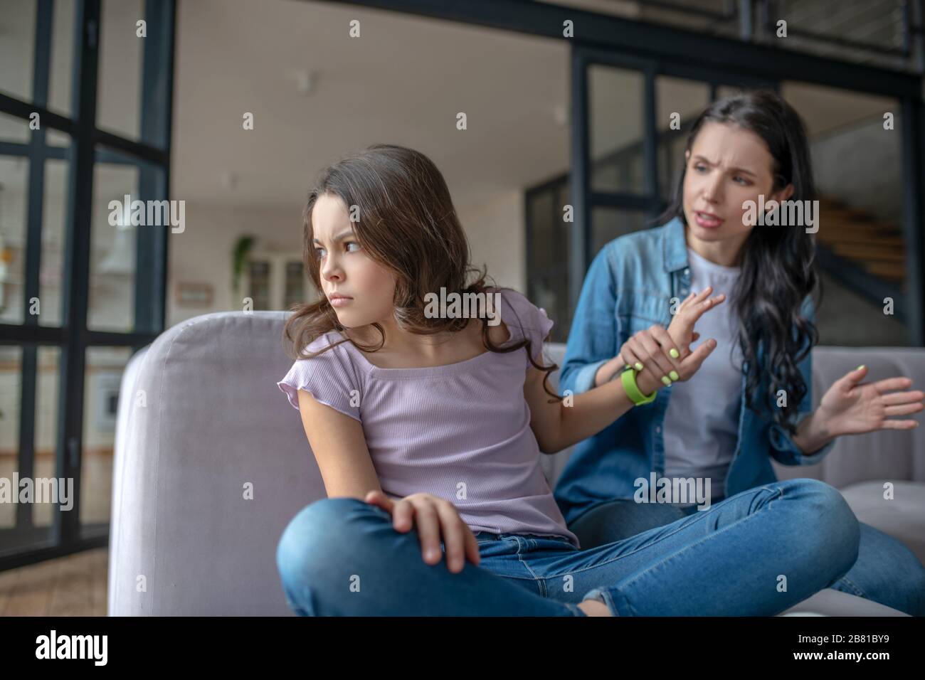 Dark-haired cute teenager looking stressed and moody Stock Photo - Alamy