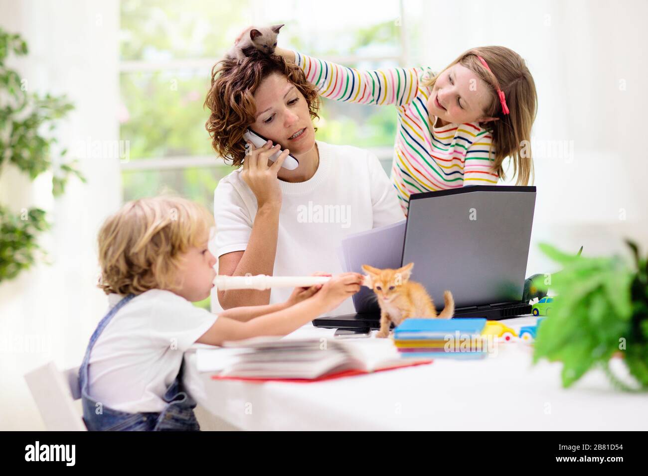 Mother working from home with kids. Quarantine and closed school during ...