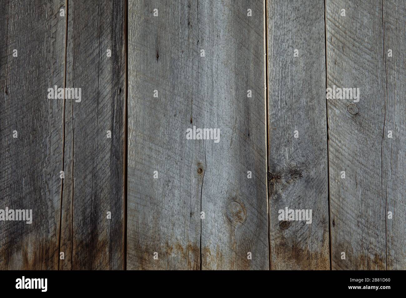 Texture of old gray wood with water smudges below. Hooks and cracks are ...