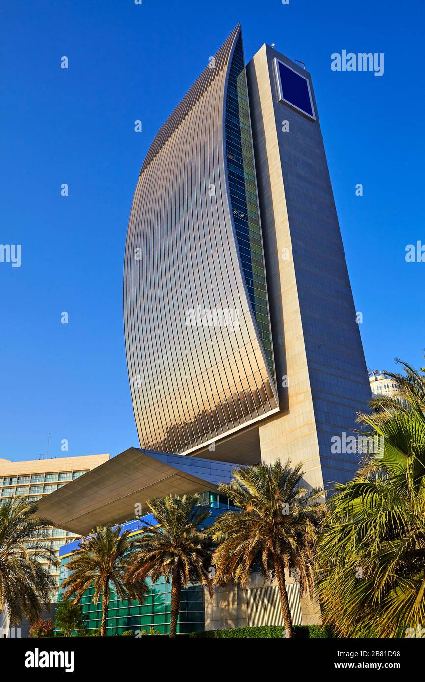 "National Bank of Dubai" skyscraper alongside Dubai Creek against blue ...