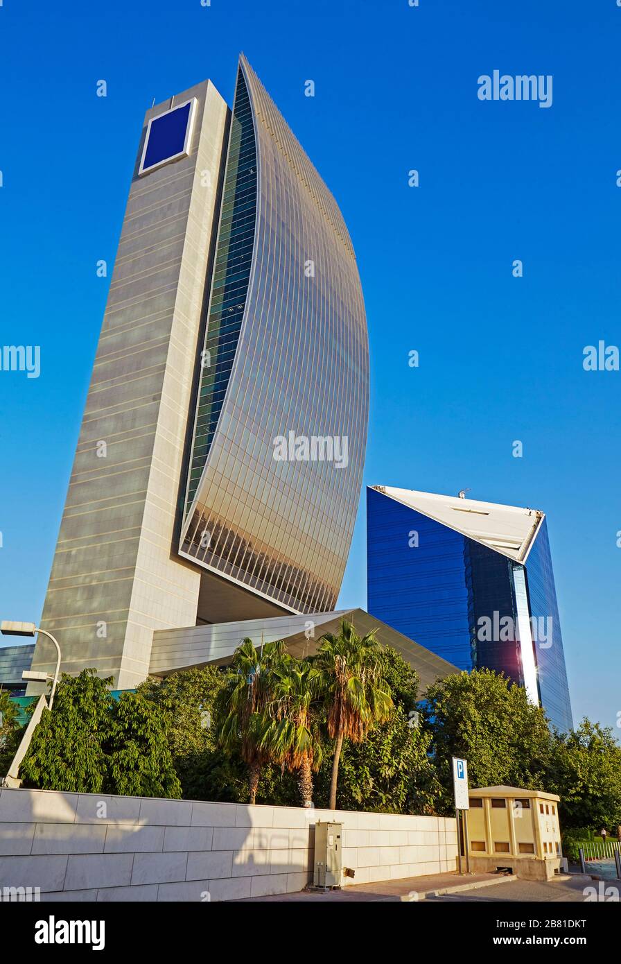 "National Bank of Dubai" skyscraper alongside Dubai Creek against blue ...