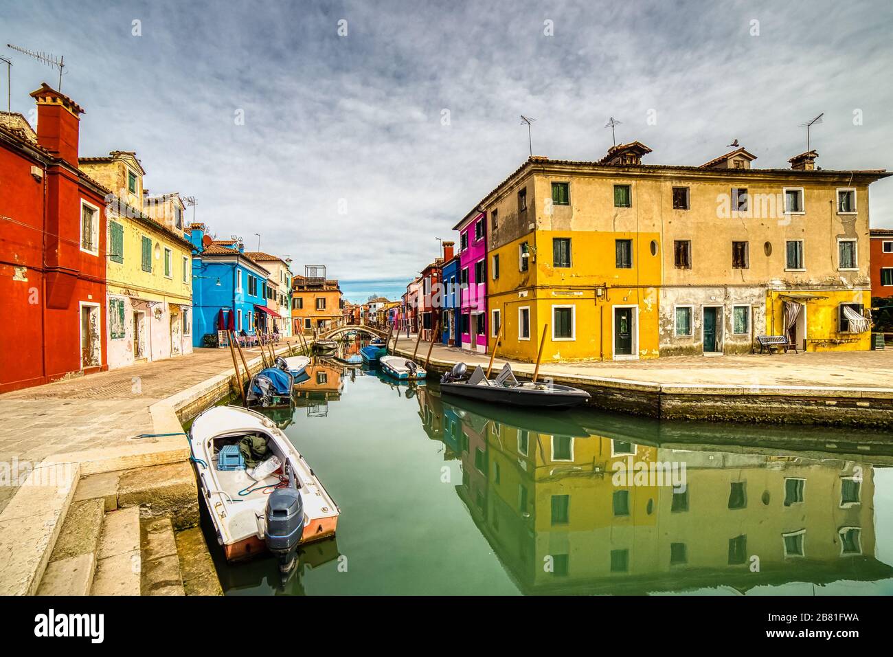 water flowing in channel running through the colorful houses of the ...