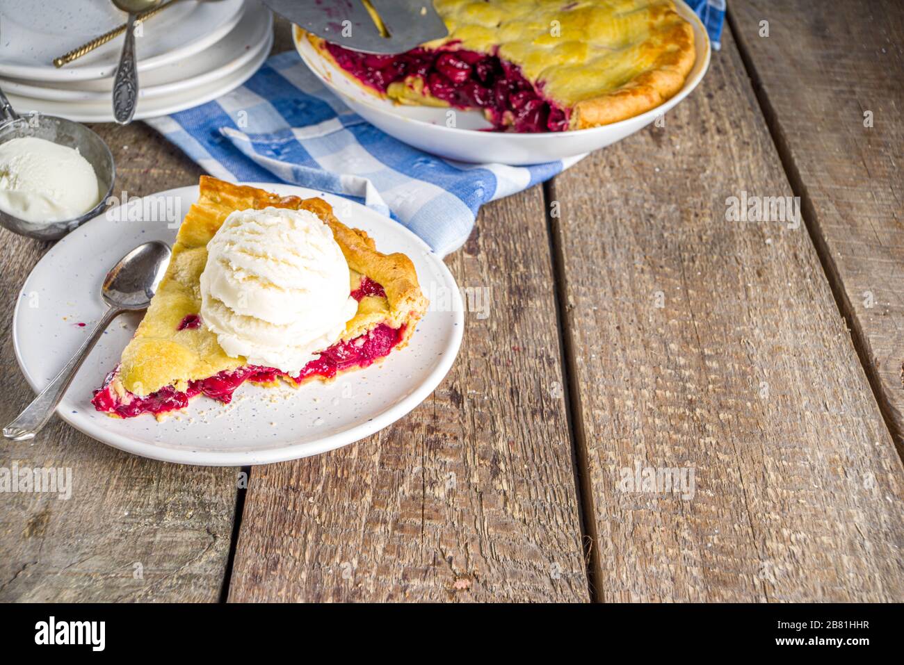 Homemade sweet sour cherry pie with vanilla ice cream, rustic wooden background copy space Stock ...