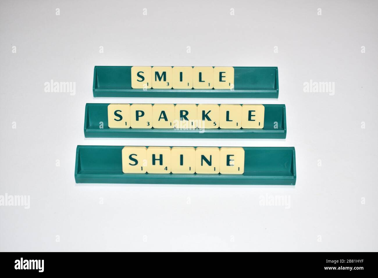 Scrabble tiles spell out Smile Sparkle Shine Motivational quote ...