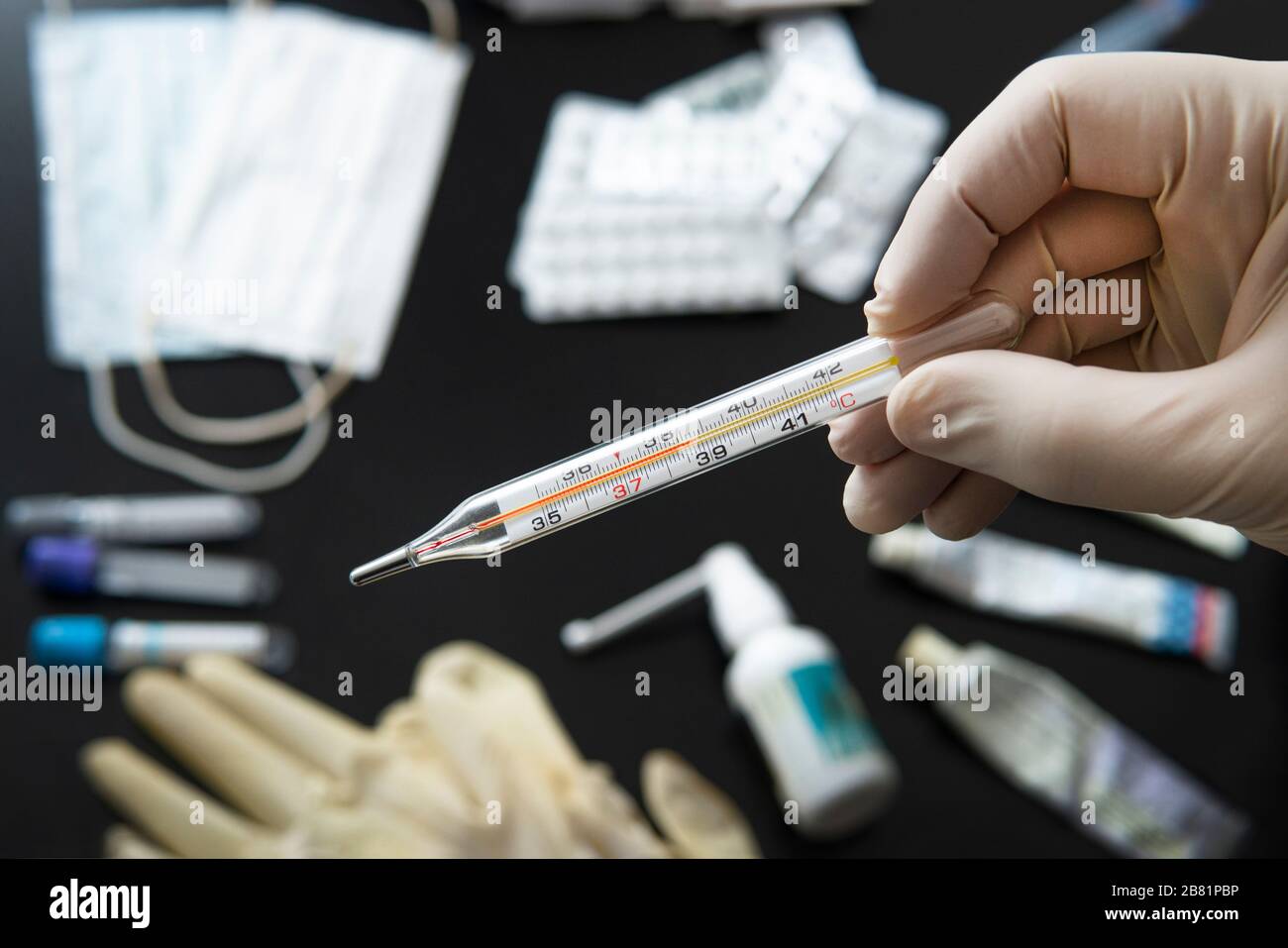 thermometer with a high temperature against background of various ...