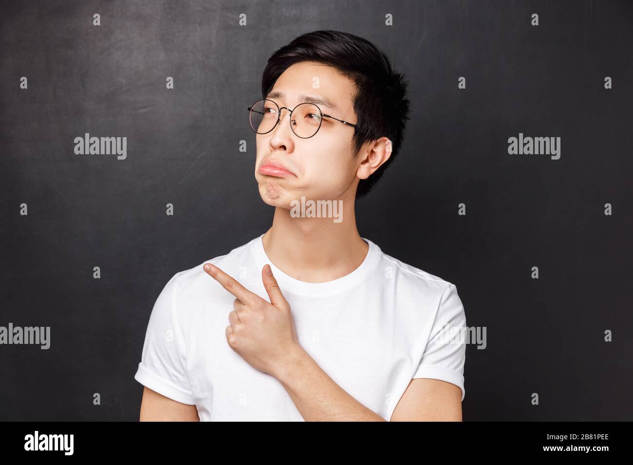 Close-up portrait of jealous and gloomy asian young man feel regret ...