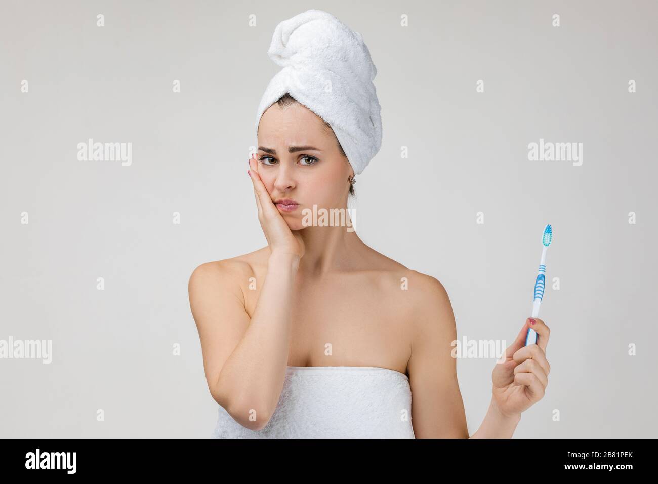 young sad caucasian woman with tooth brush suffering from tooth pain or ...