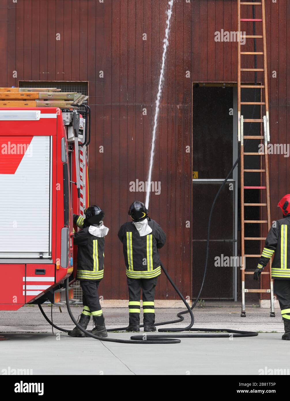 the fire engine and the brave firefighters engaged with a hydrant to ...