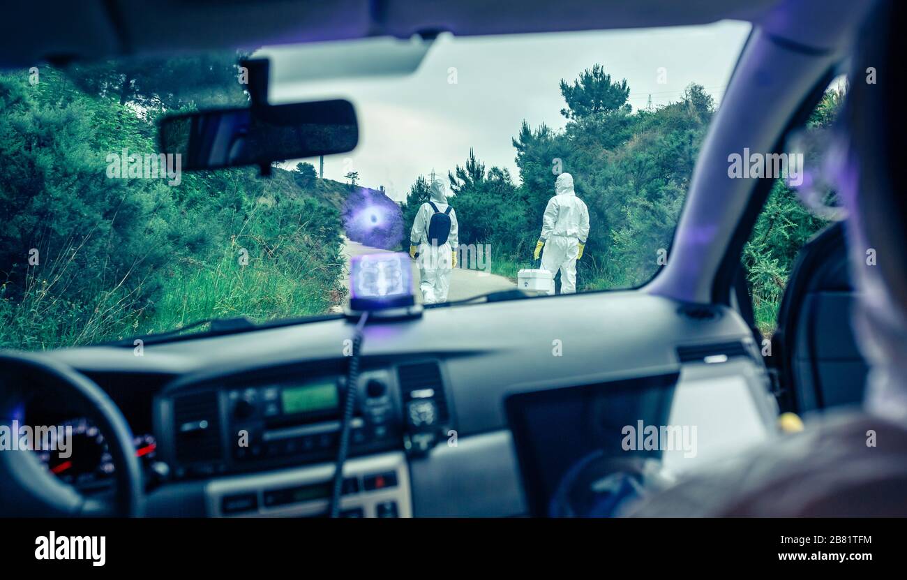 View from inside the car of people in bacteriological protection suits ...