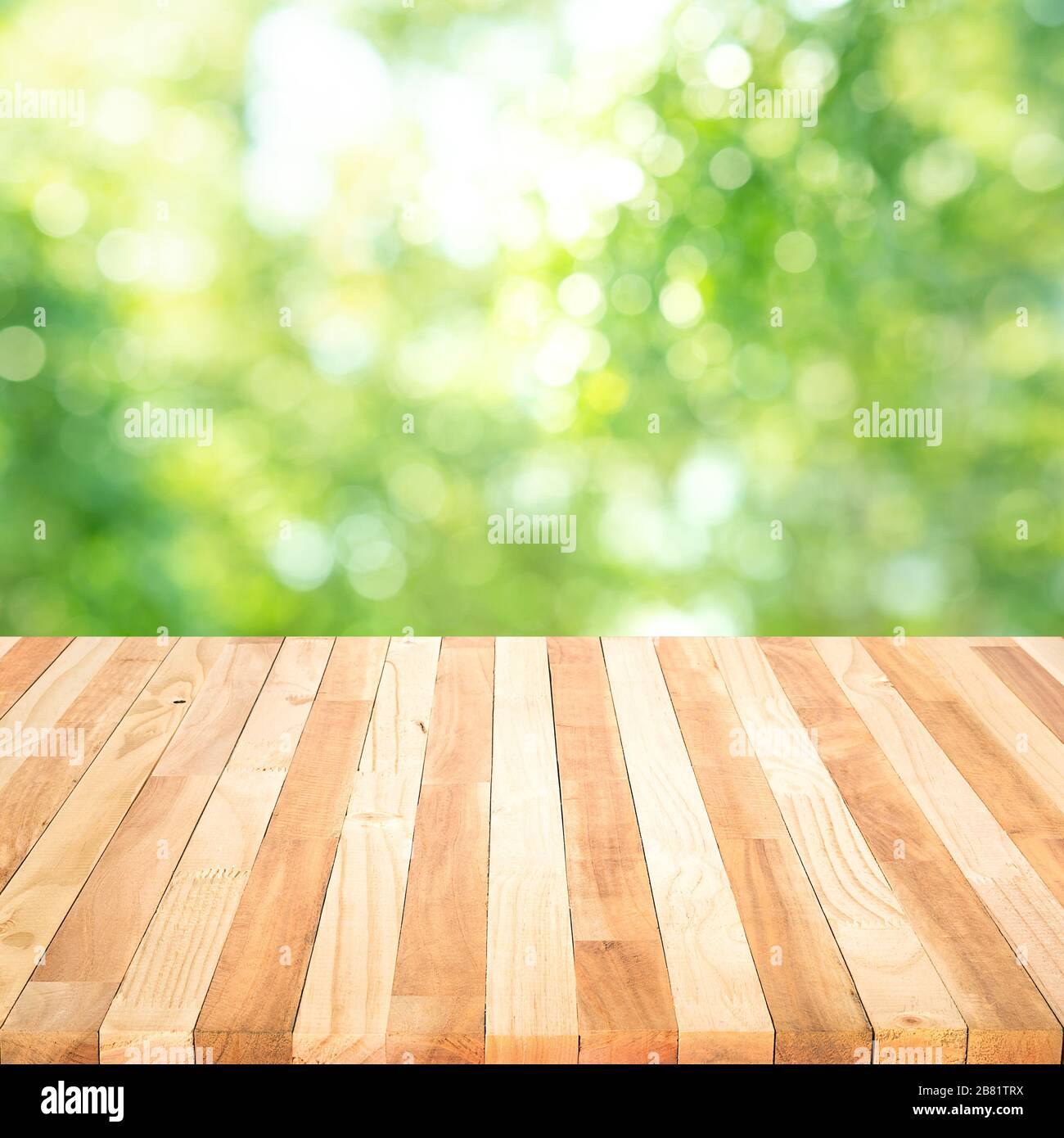 Real wood table top texture on blur leaf tree garden background.For ...