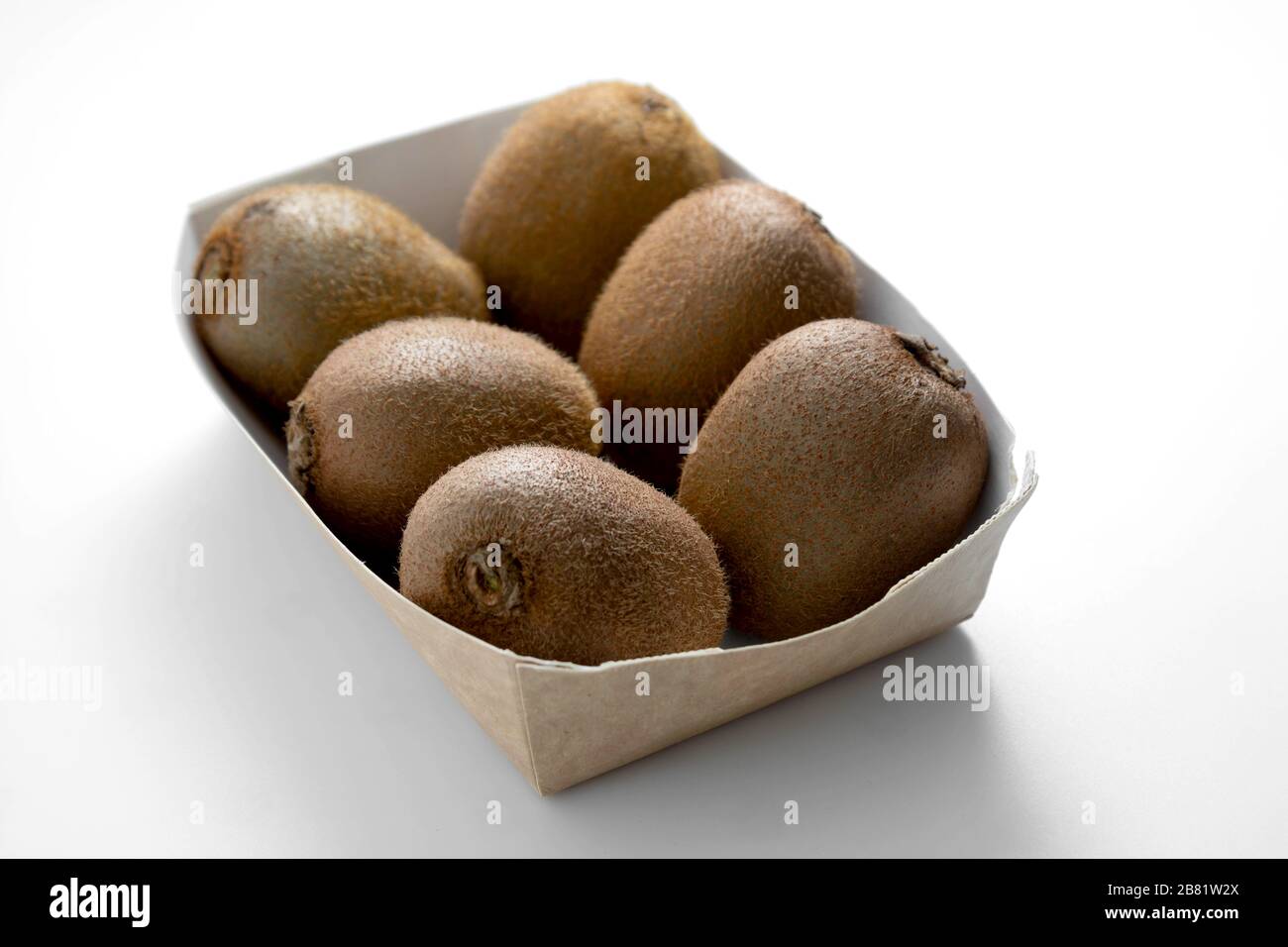 Kiwi in white pack, six fresh whole kiwi fruits, isolated Stock Photo ...