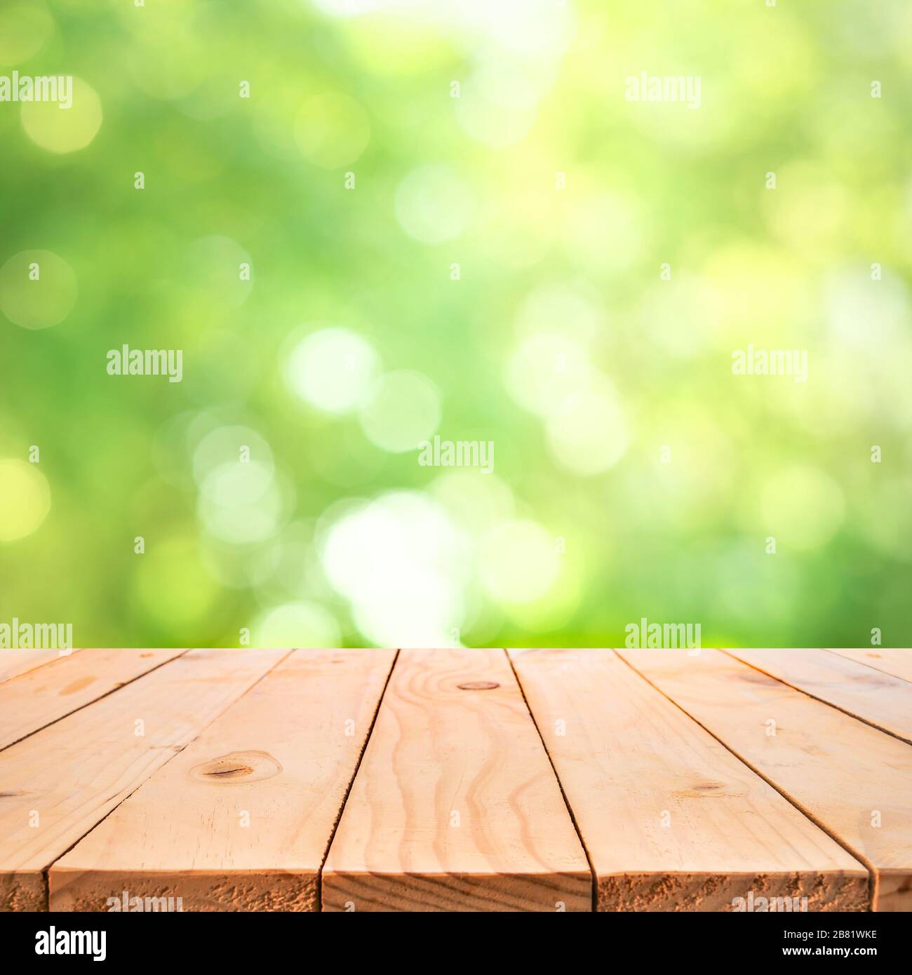 Real wood table top texture on blur leaf tree garden background.For ...