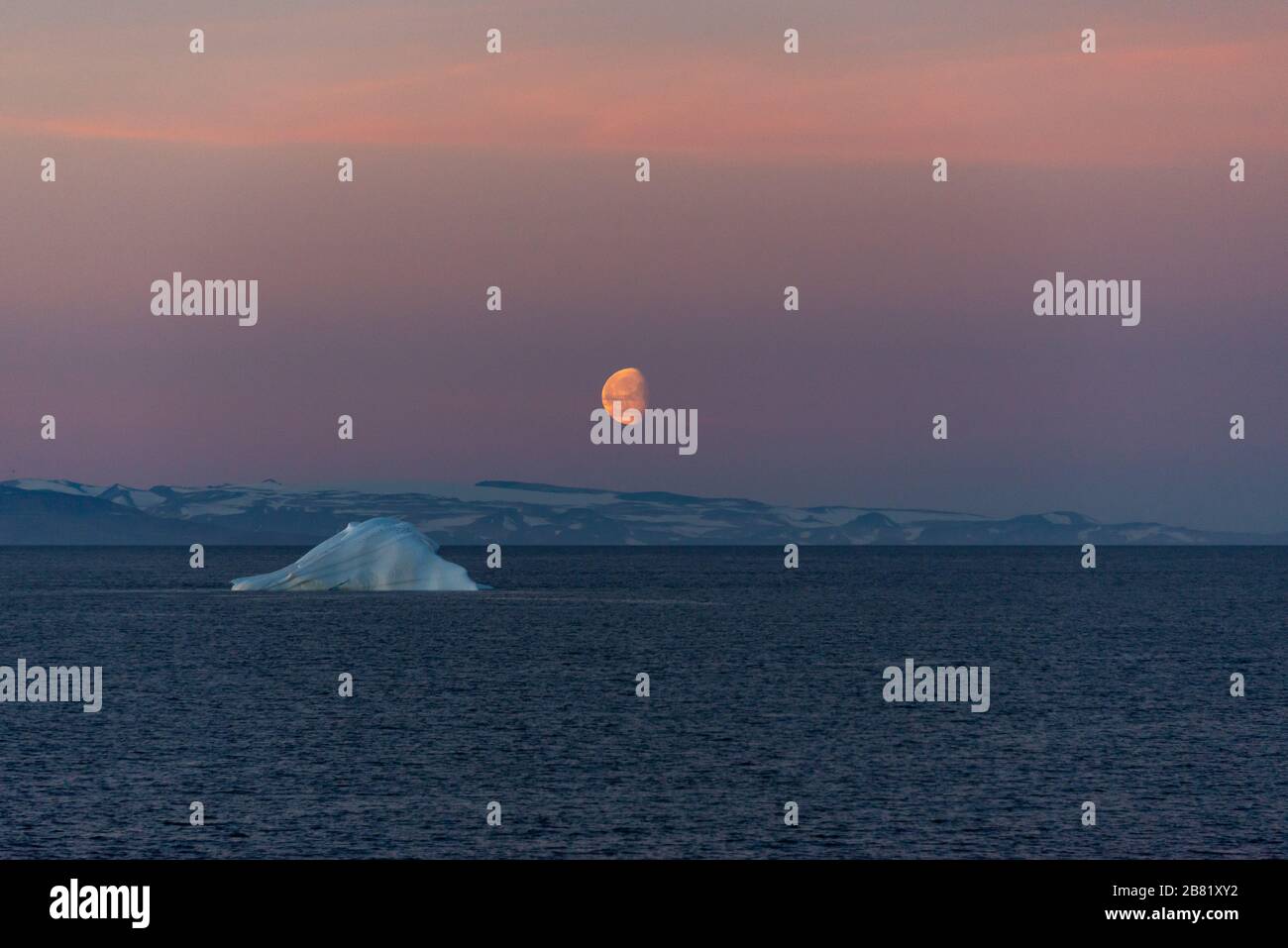 Beautiful moonrise in Greenland. Iceberg at sea Stock Photo - Alamy