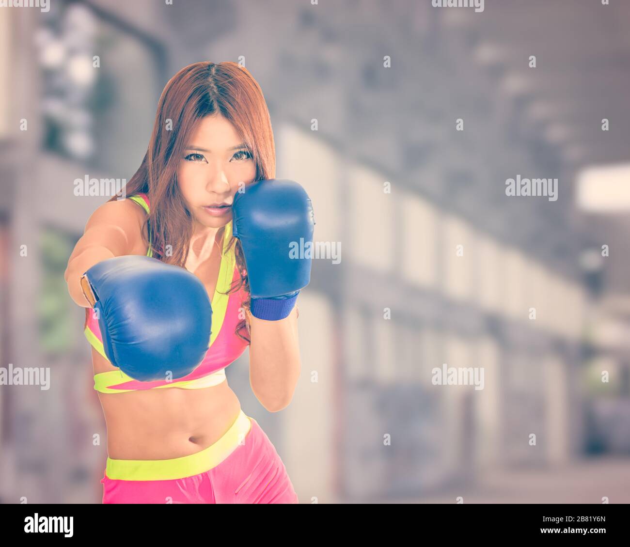 Chinese woman boxing in grungy setting Stock Photo - Alamy