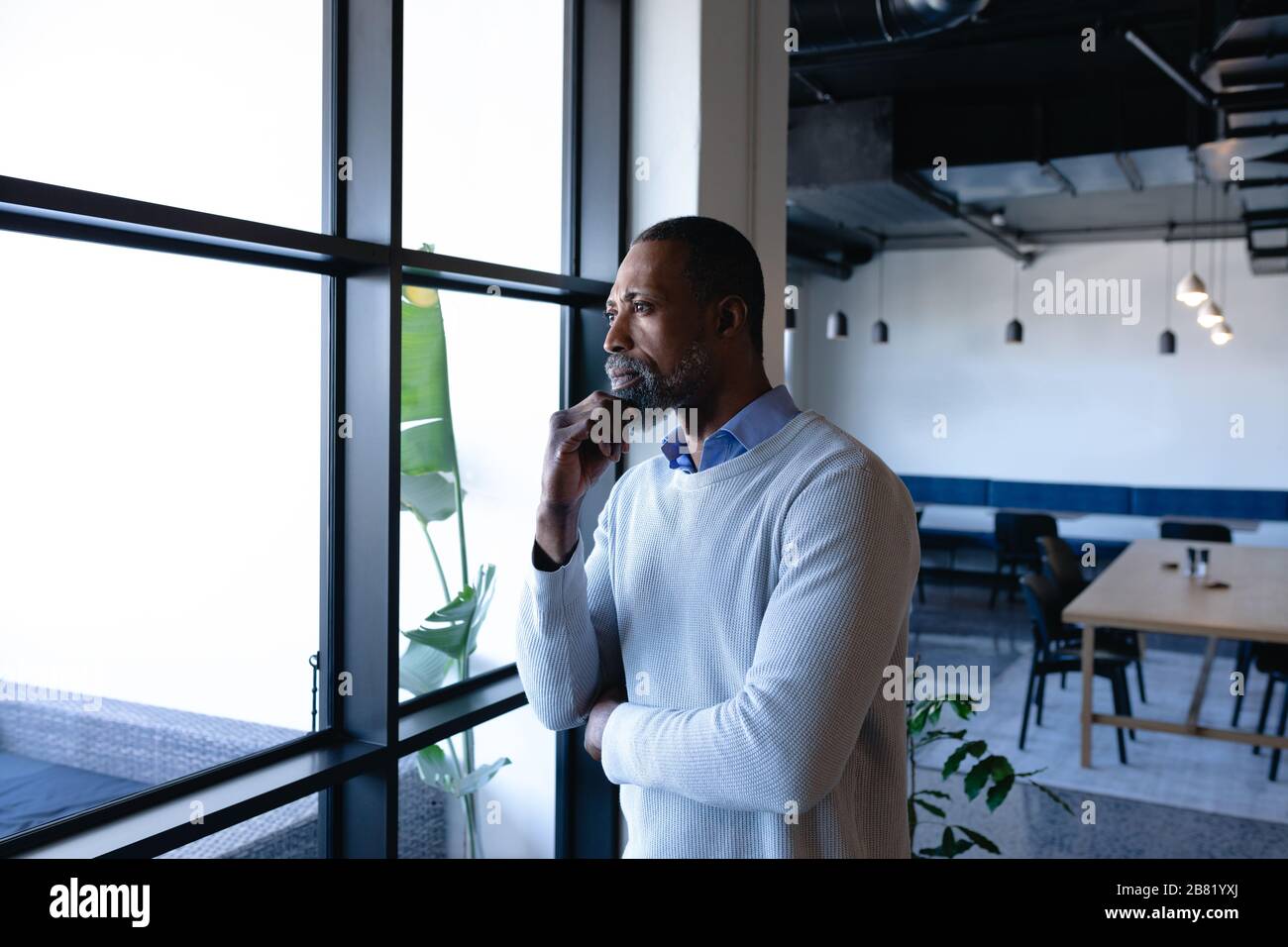 African American man looking outside and thoughtful Stock Photo - Alamy