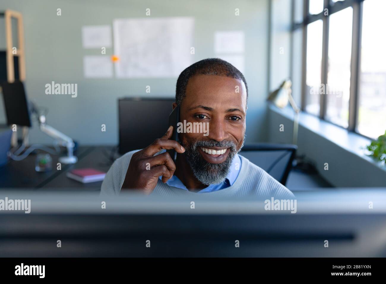 African businessman working on desktop hi-res stock photography and ...