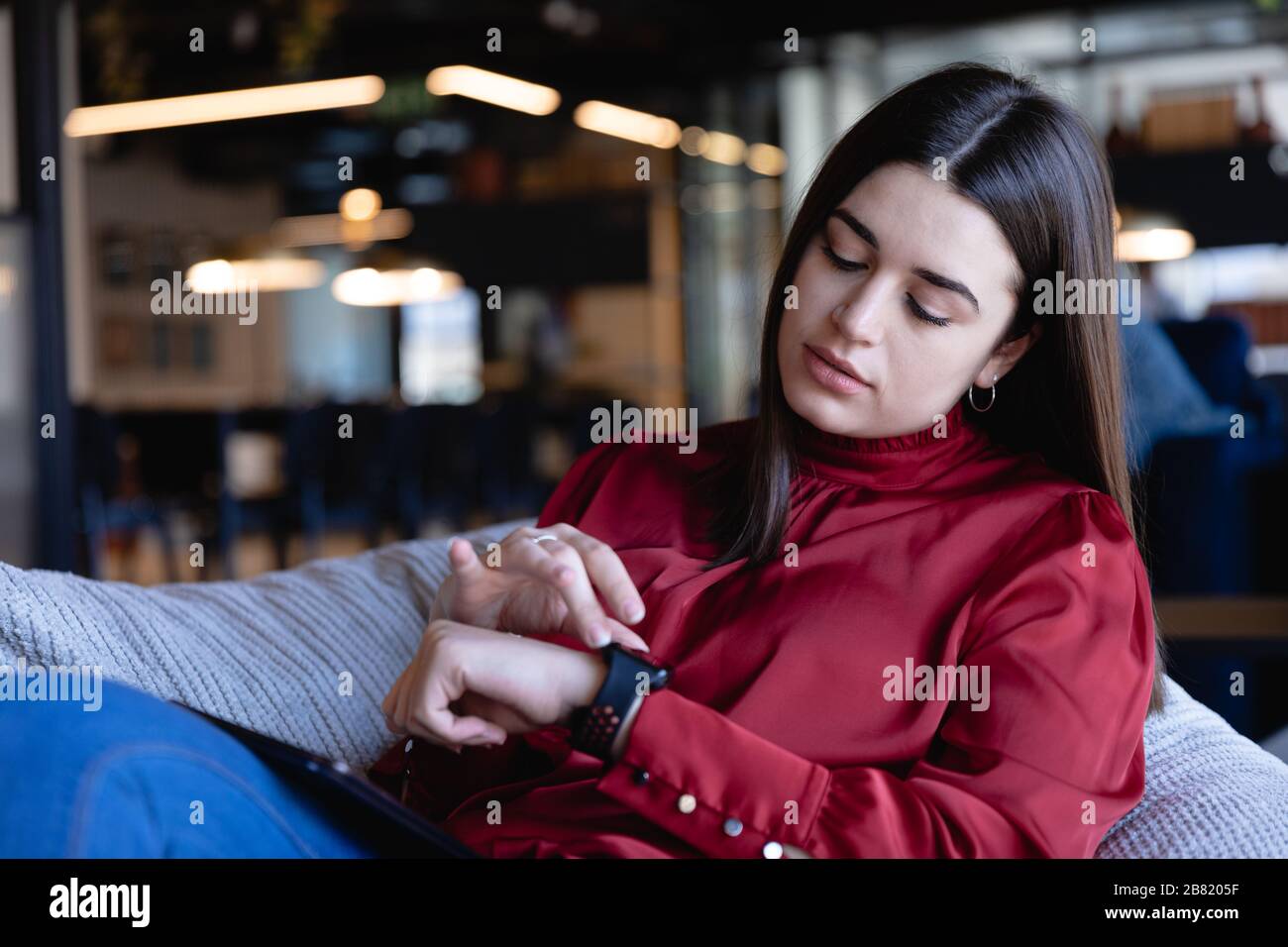 Caucasian woman looking at her digital watch Stock Photo - Alamy