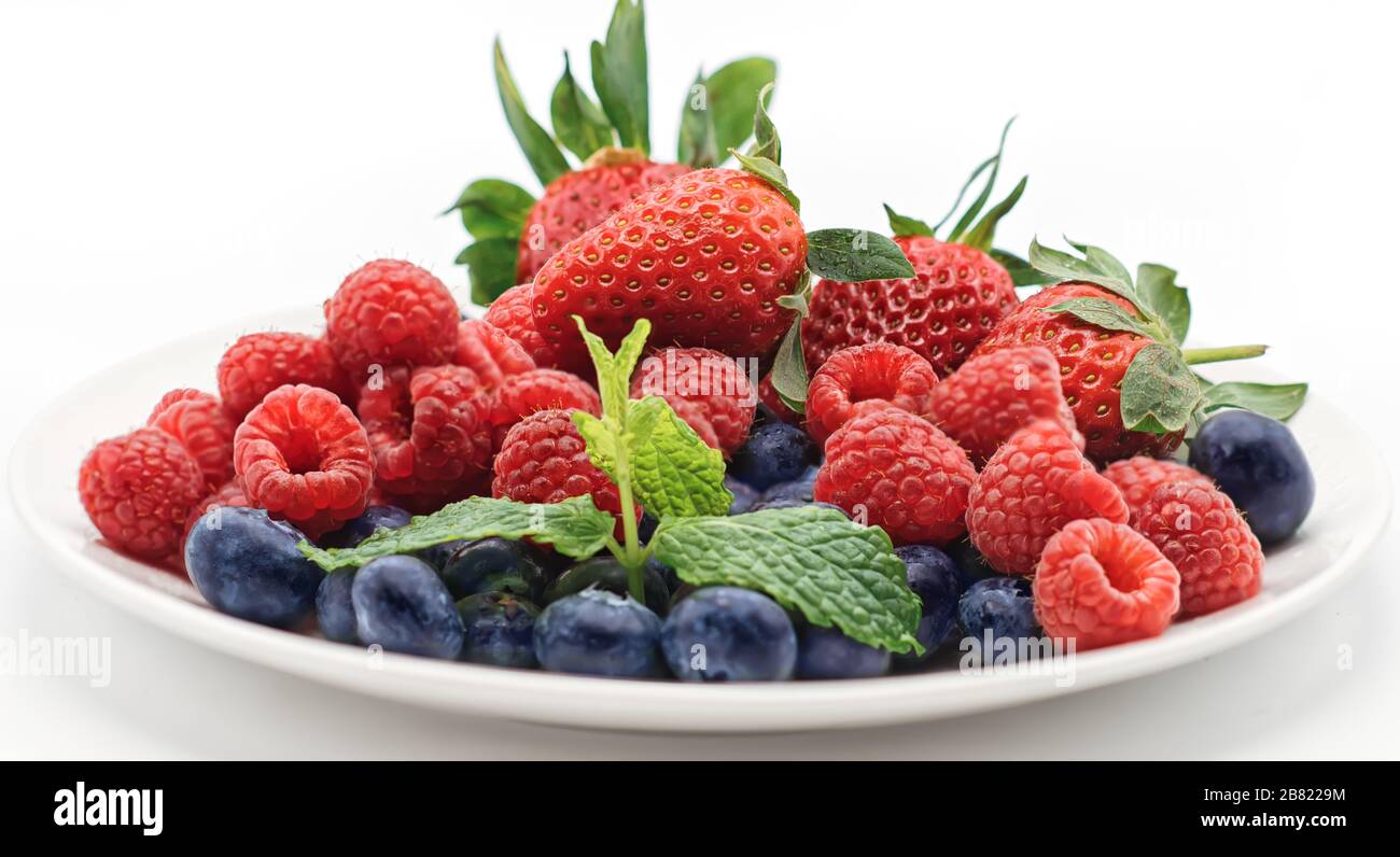 Different fresh summer berries (raspberry, blackberry, strawberry) with ...