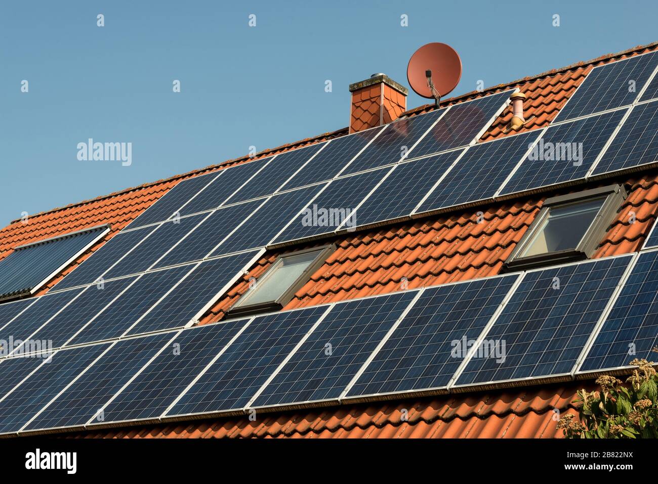 Solar panel on a red roof Stock Photo - Alamy