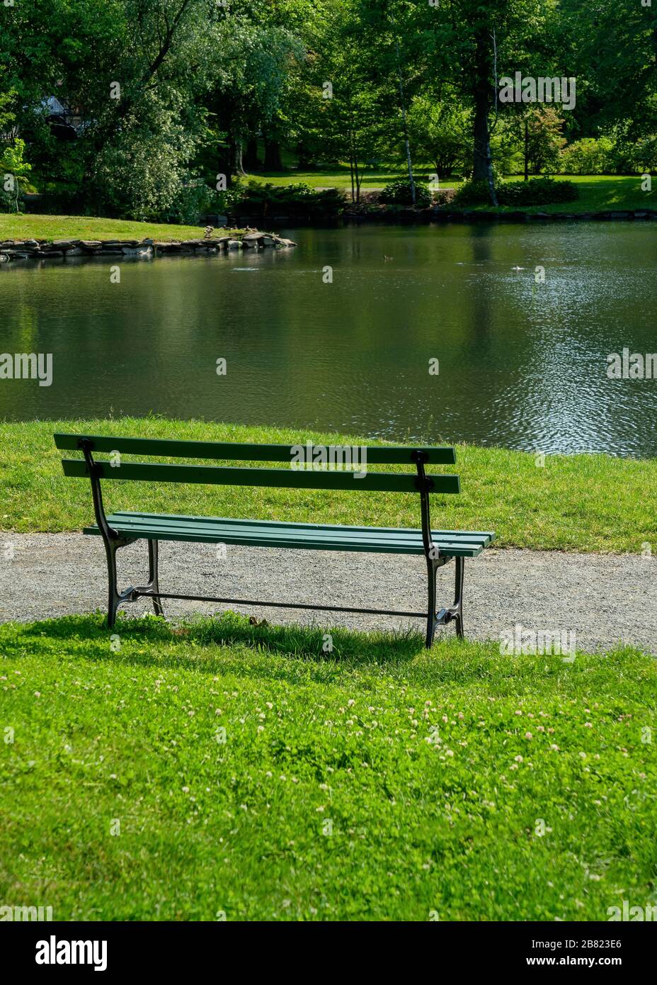 Empty bench with a view of a lake Stock Photo - Alamy