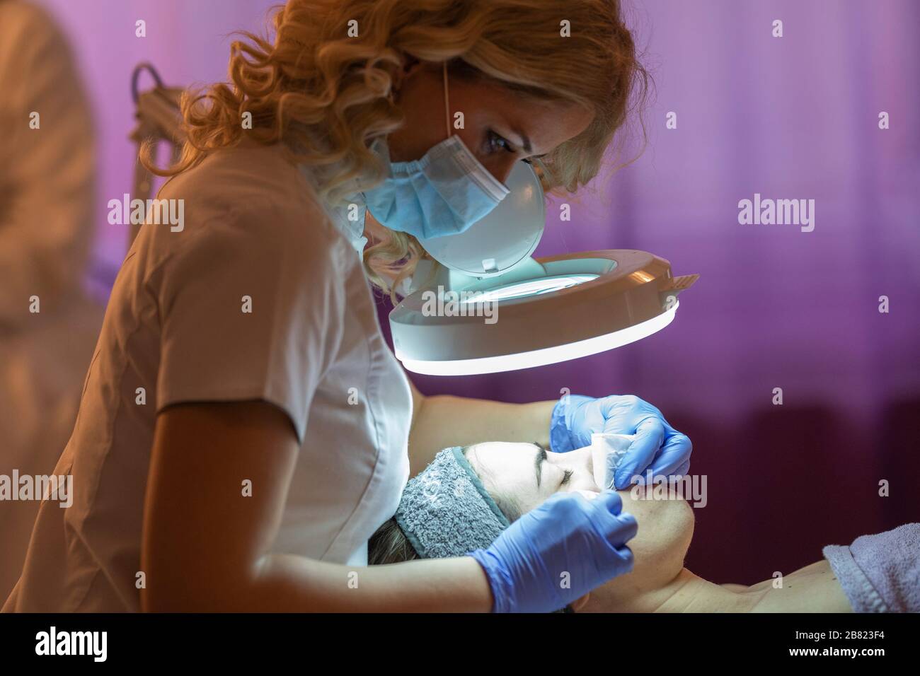 Face Treatment. Woman in Beauty Salon Gets Marine Mask Stock Photo - Alamy
