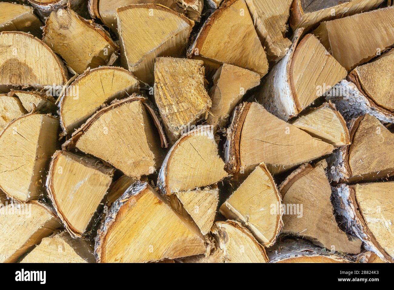 wooden logs stacked together on top of each other. Wall of stacked wood ...
