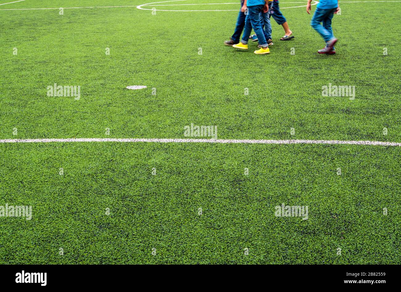 Children play on the artificial turf of the school Stock Photo - Alamy