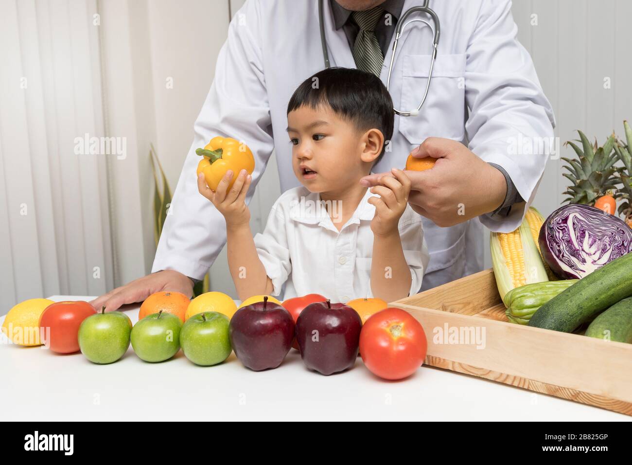 A boy and doctor happy to have healthy food. Kid learning about ...