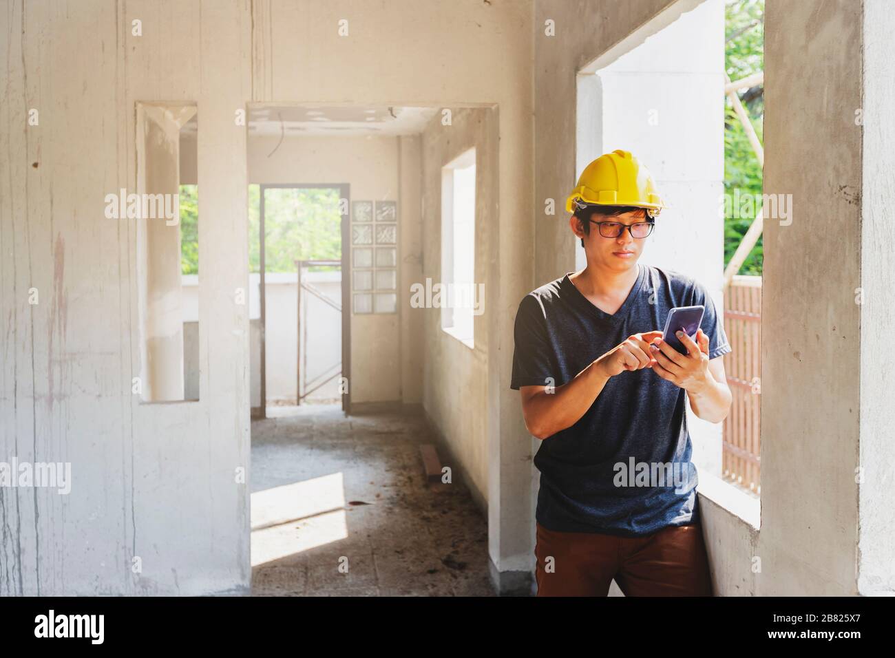 Engineer or Architect using cell phone in building construction site ...