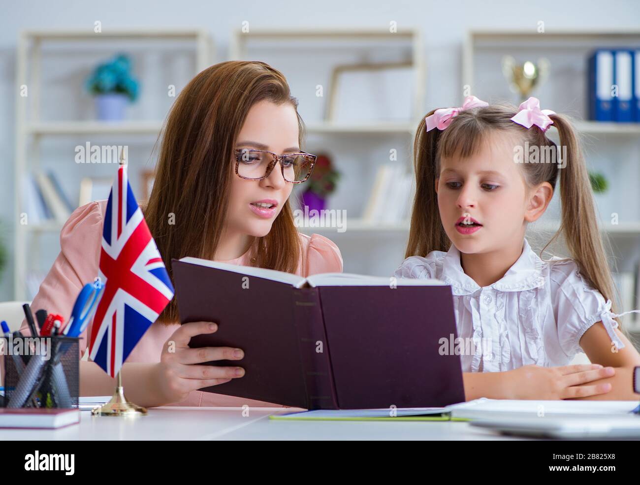 The young girl learning english with teacher Stock Photo - Alamy