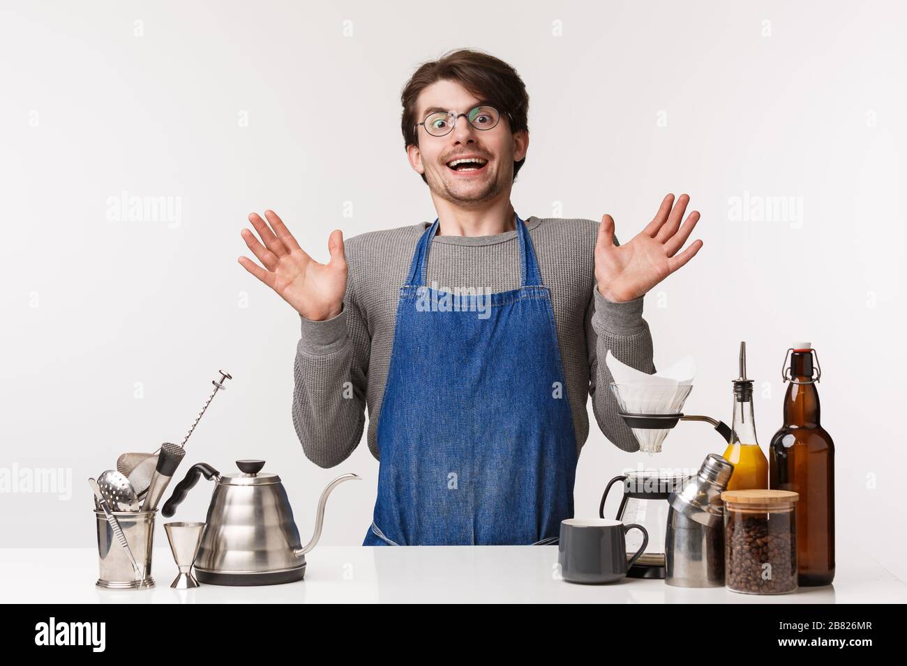 Barista, cafe worker and bartender concept. Surprised happy young man ... Barista, cafe worker and bartender concept. Surprised happy young man ...
