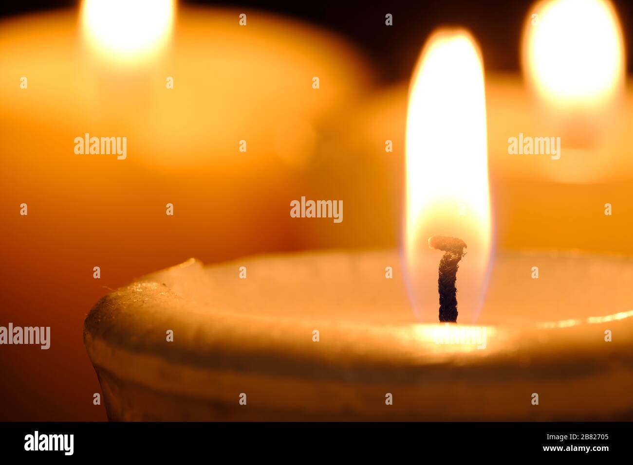 One candle flame at night closeup view Stock Photo - Alamy