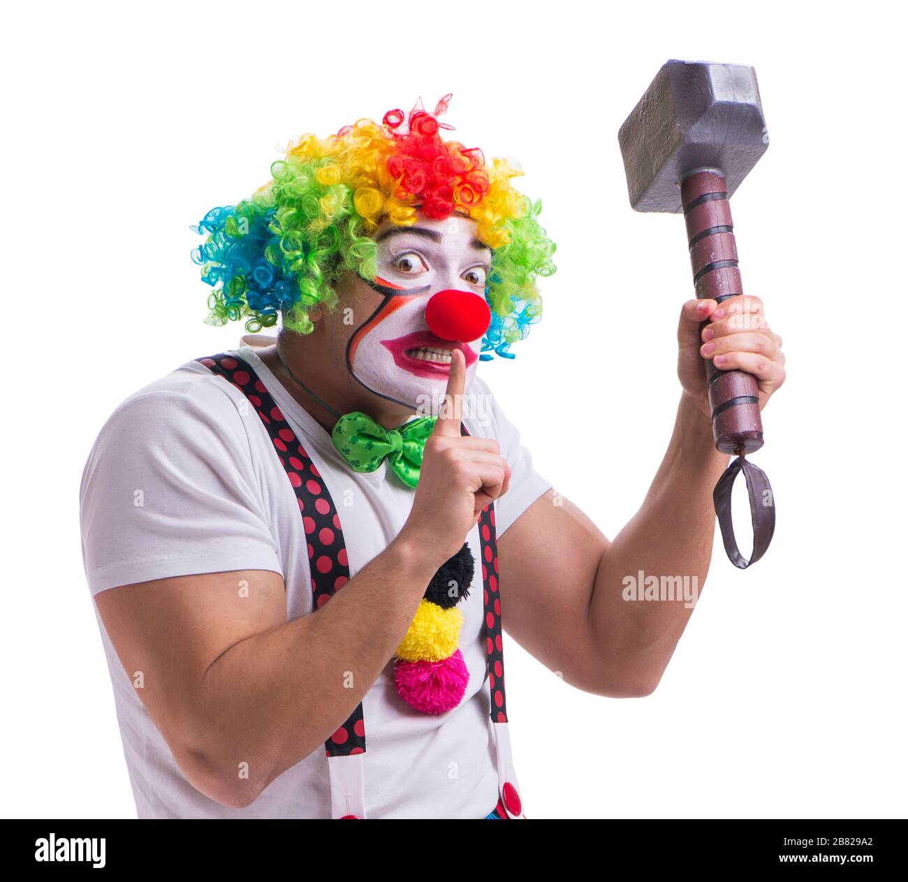 The funny clown with a hammer isolated on white background Stock Photo ...